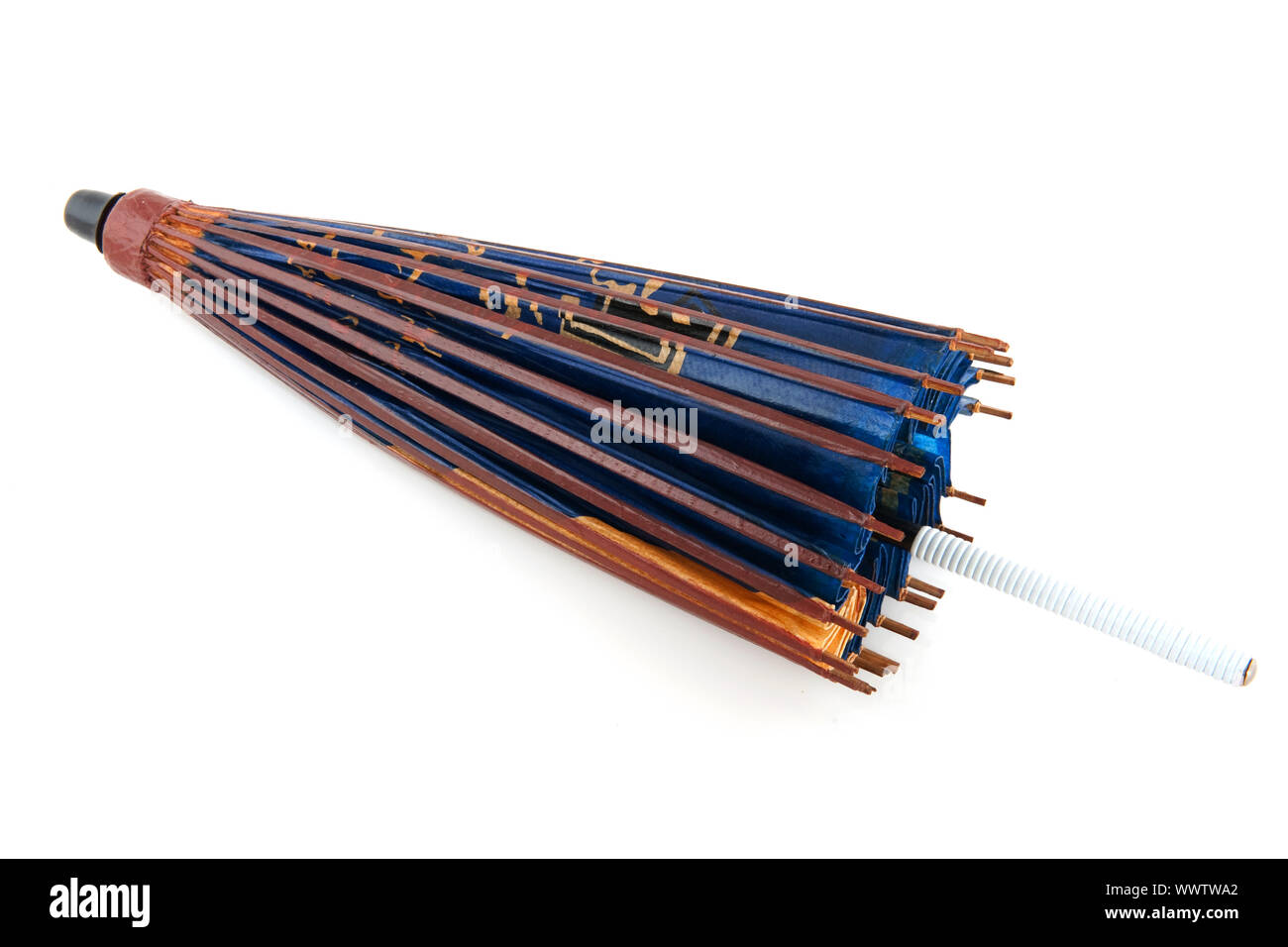 Folded tropical parasol for having shadow on the beach Stock Photo - Alamy