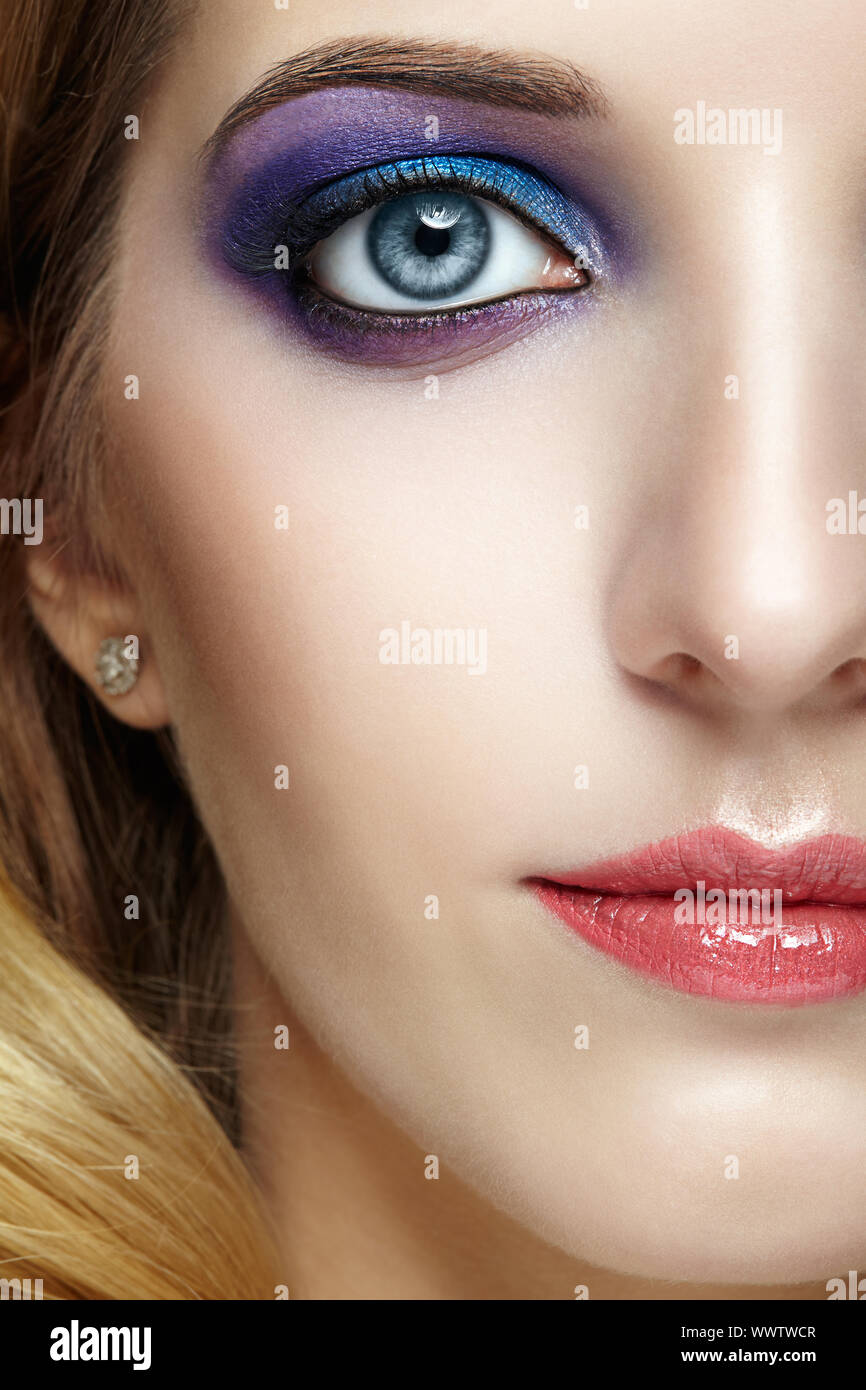Female half face with and violet and blue eyes makeup Stock Photo - Alamy