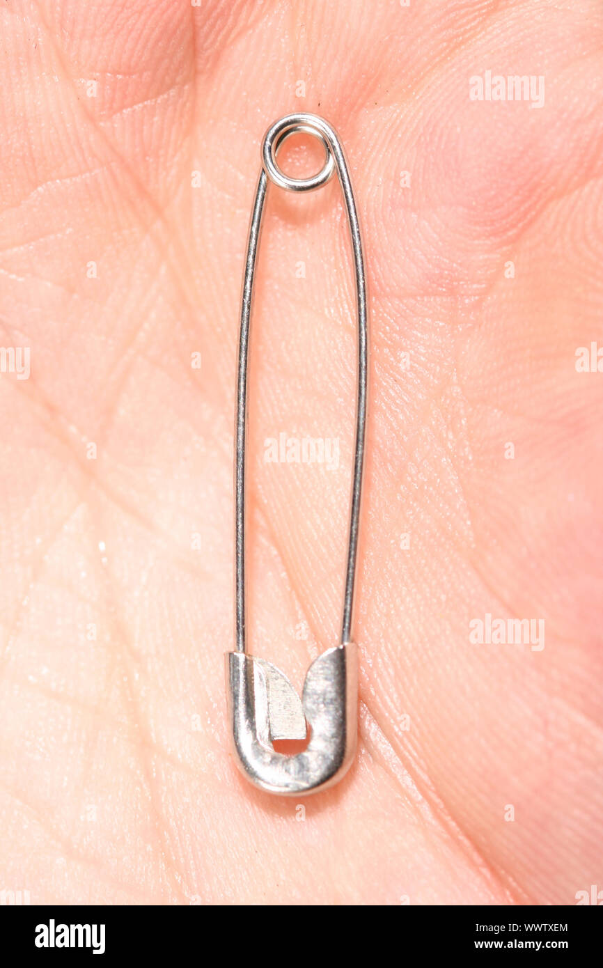 iron Pin in man hand close up Stock Photo - Alamy