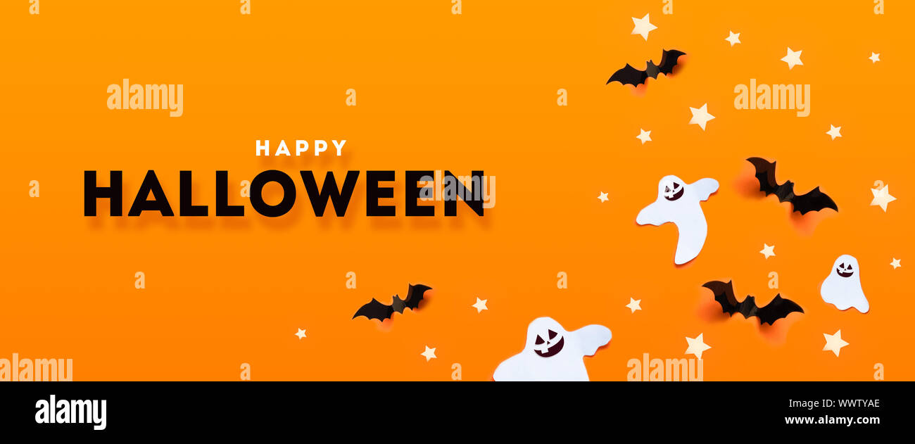 Halloween decor frame with bats, ghost, spider web, stars over a orange ...