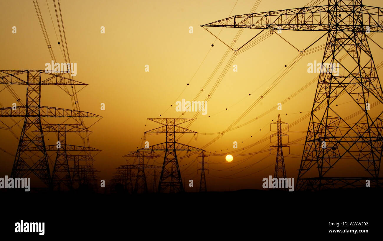 Electricity Pylons over sunset Stock Photo - Alamy