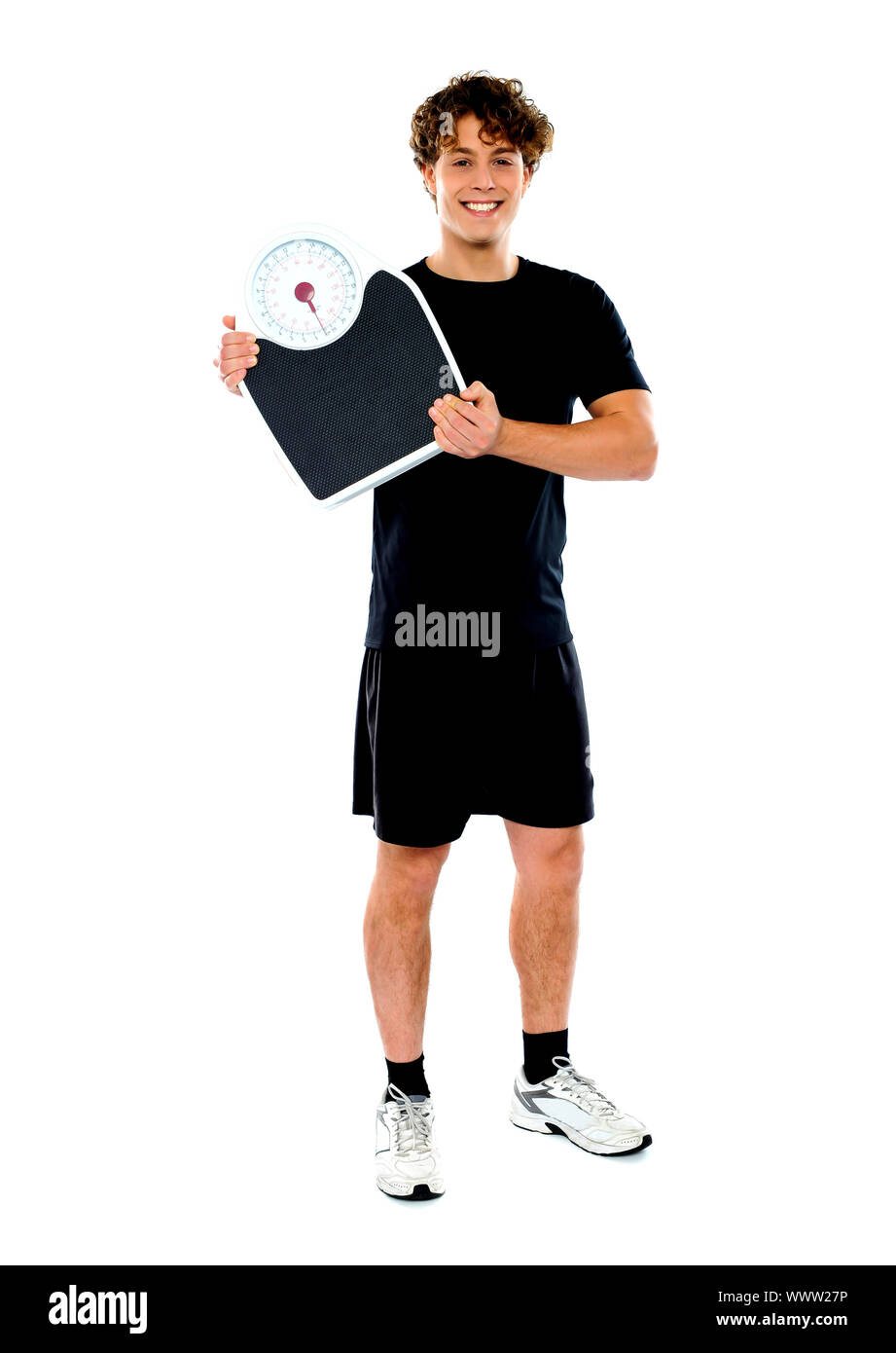 Handsome fit man holding weight machine over white background ...