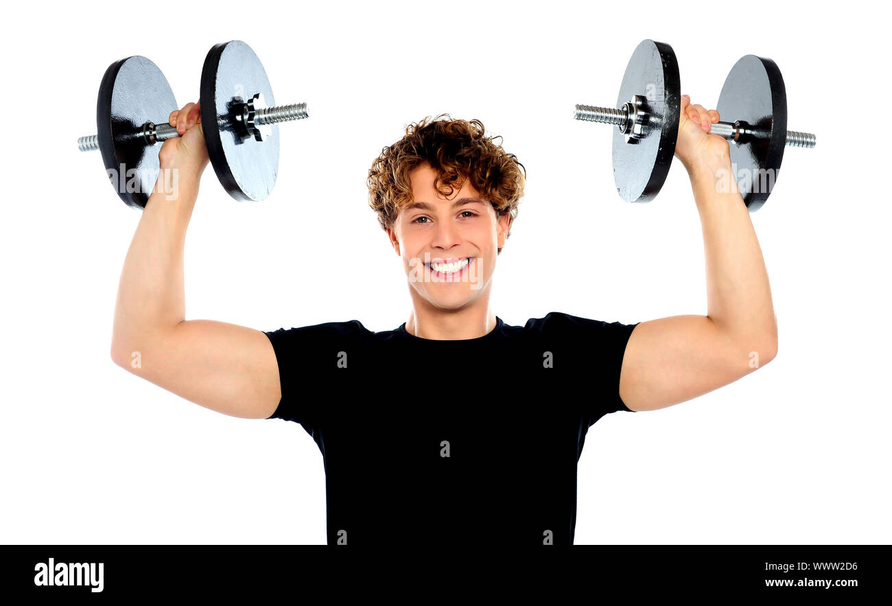 Smiling athlete wearing sporty outfit, lifting weights Stock Photo - Alamy