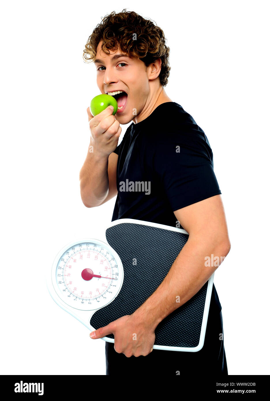 Smart boy eating green apple with scale in his other hand Stock Photo ...