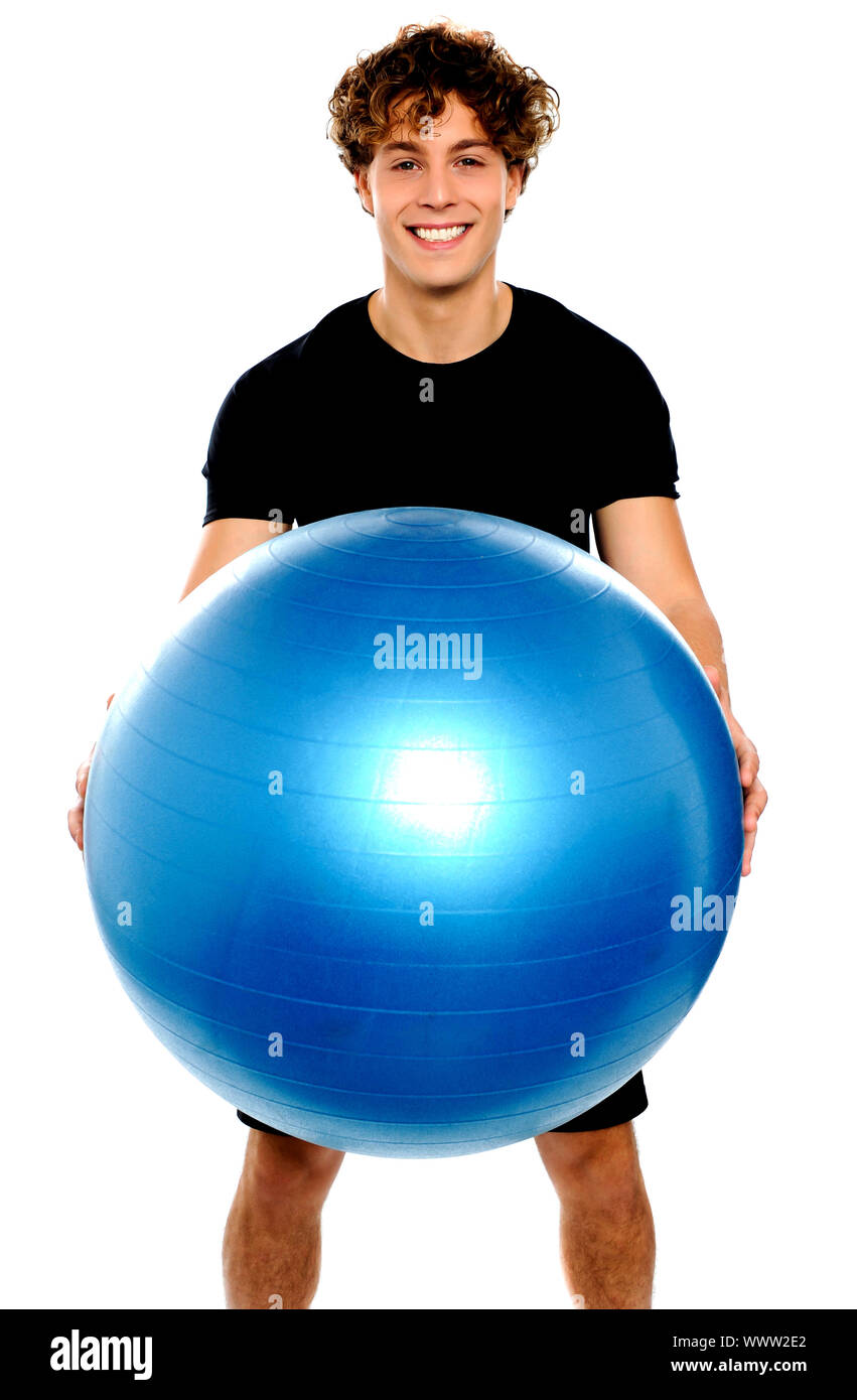 Man in sportswear holding big ball isolated against white background ...