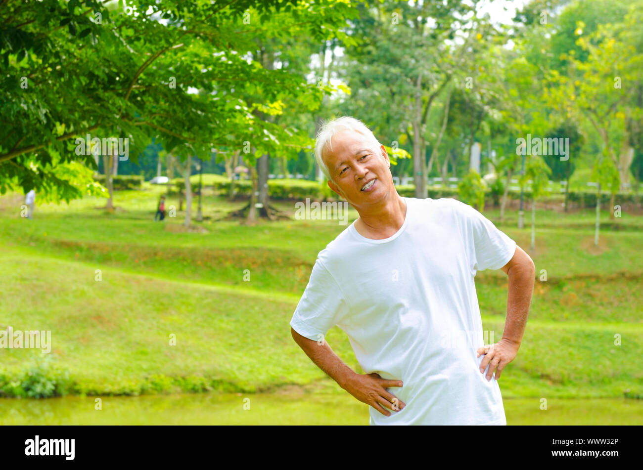 Retired Asian senior man exercising in park Stock Photo - Alamy