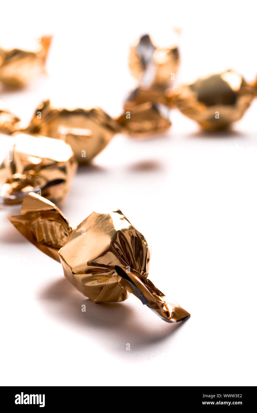 golden sweets closeup on white background Stock Photo - Alamy