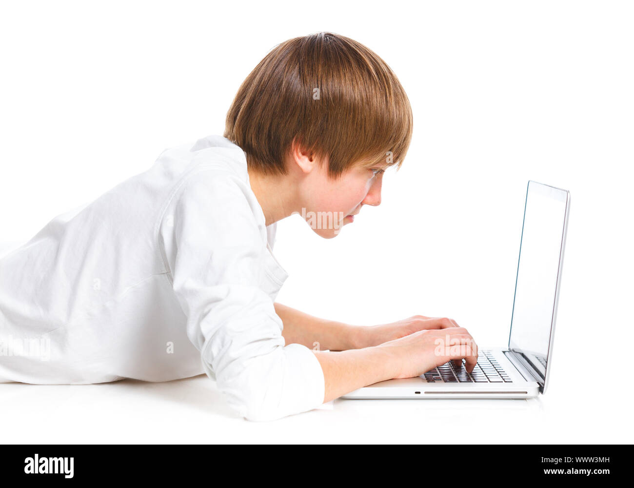 Teenager using a laptop. Isolated on white background Stock Photo - Alamy