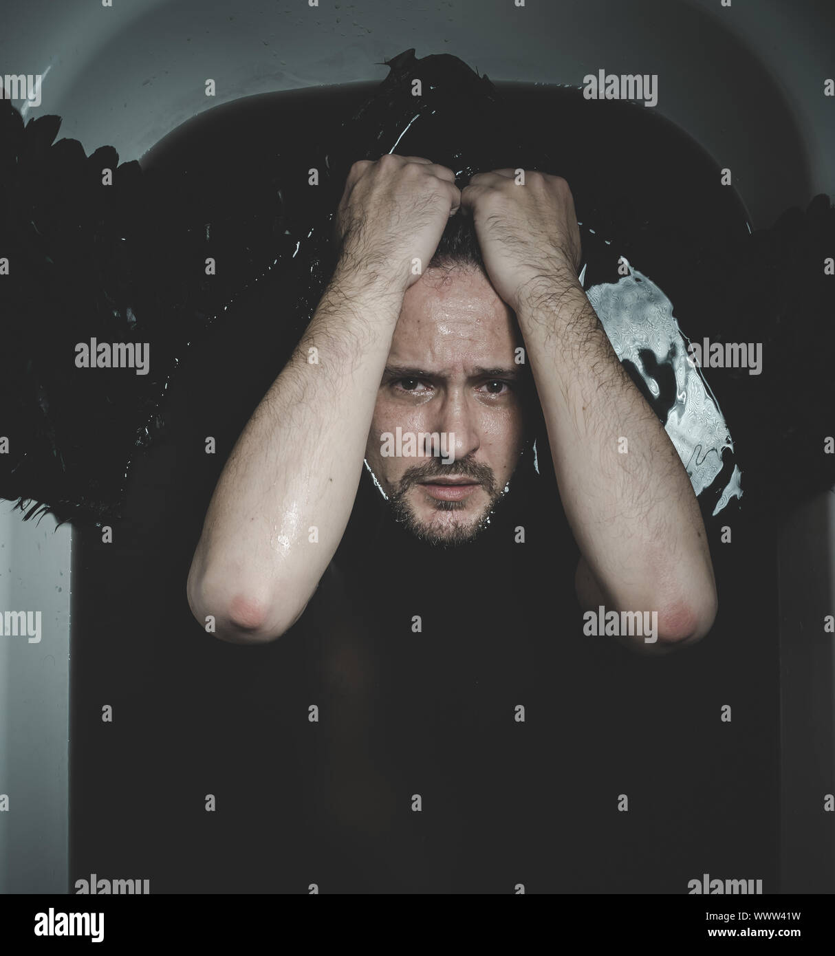 Halloween, Fallen angel, man in a bathtub with black water and wings ...