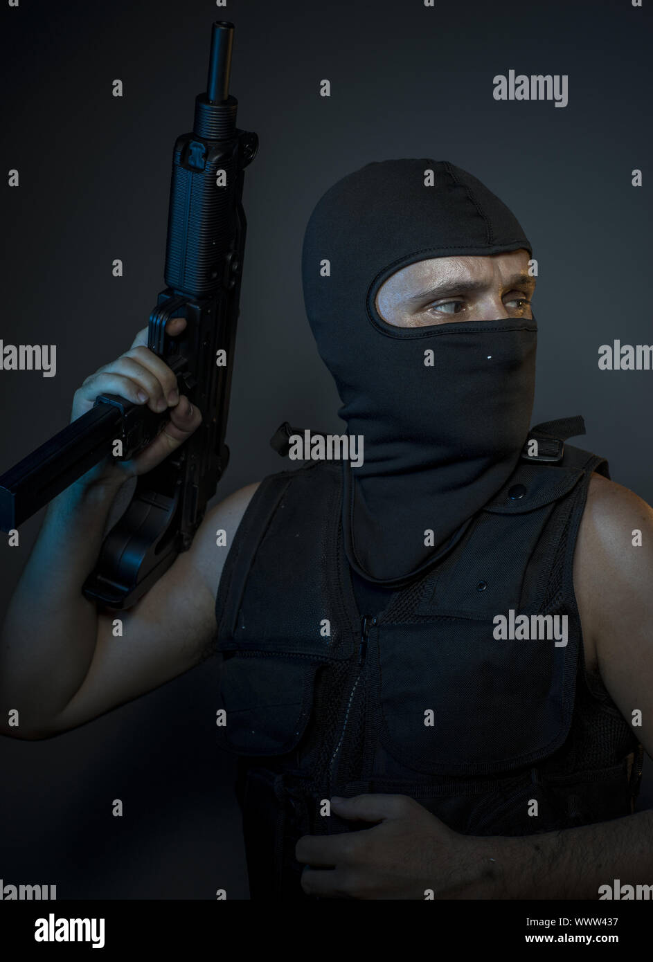 Terrorist, a man dressed in a bulletproof vest and balaclava, is armed ...