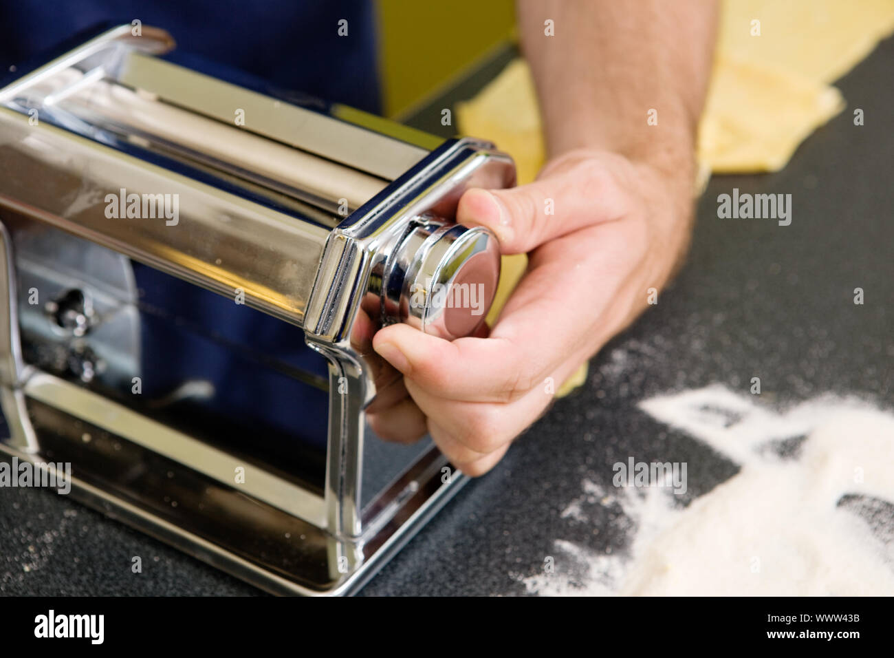 Adjusting the roller on a manual pasta machine Stock Photo - Alamy
