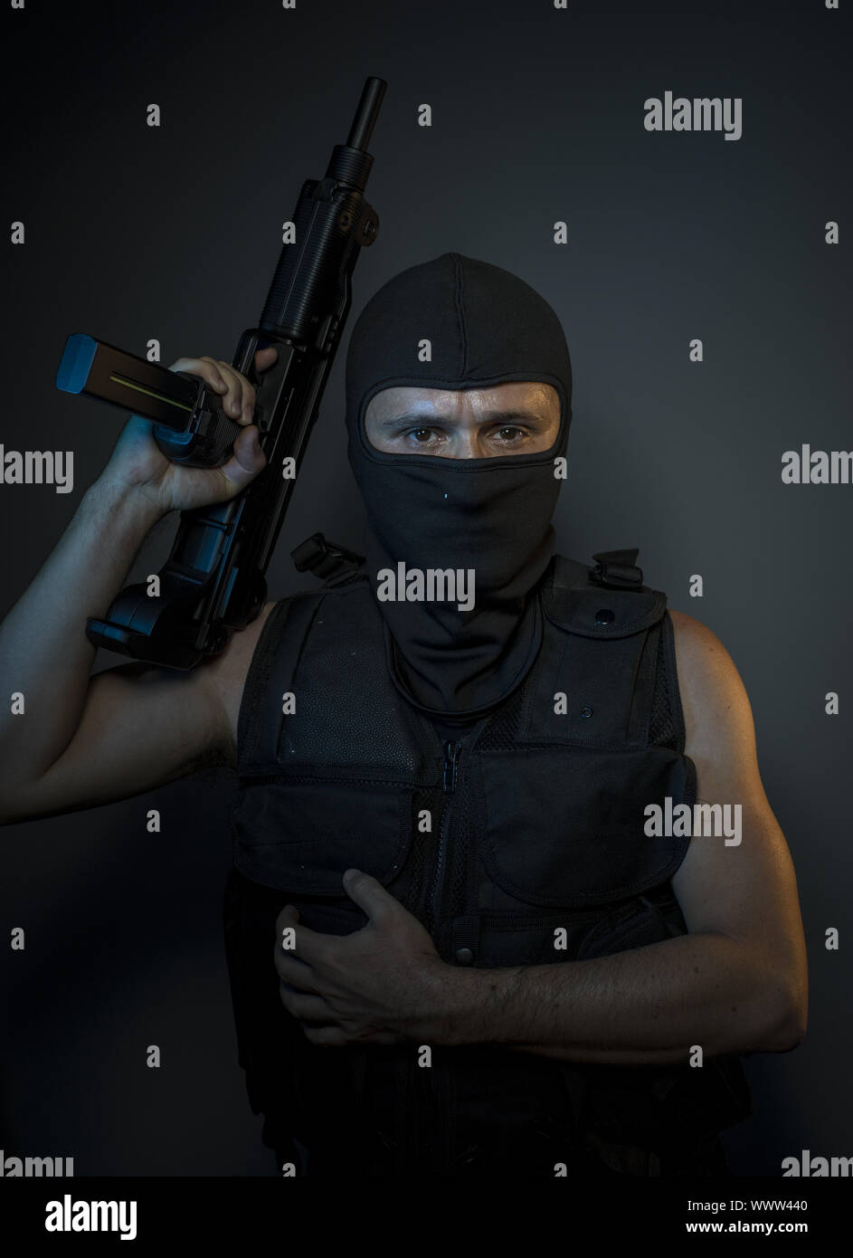 Terrorist, a man dressed in a bulletproof vest and balaclava, is armed ...