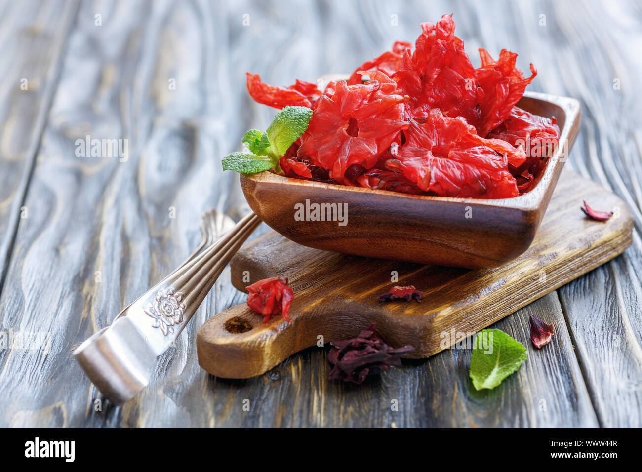 Candied hibiscus flower and a sprig of mint in a bowl Stock Photo - Alamy