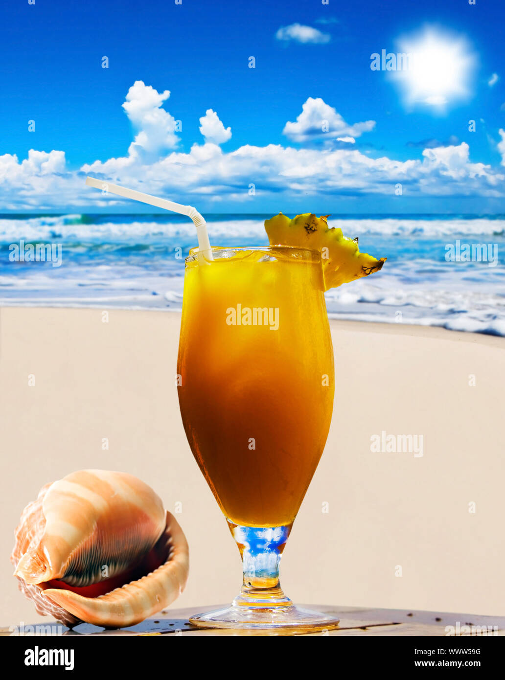 Tropical fruit cocktail and sea shell Stock Photo - Alamy