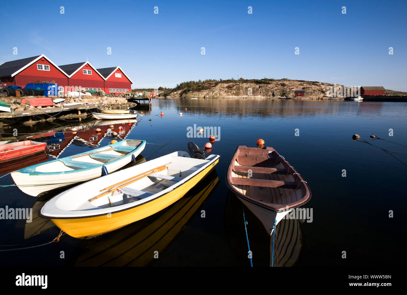 A group of small row boats tied to the dock Stock Photo - Alamy