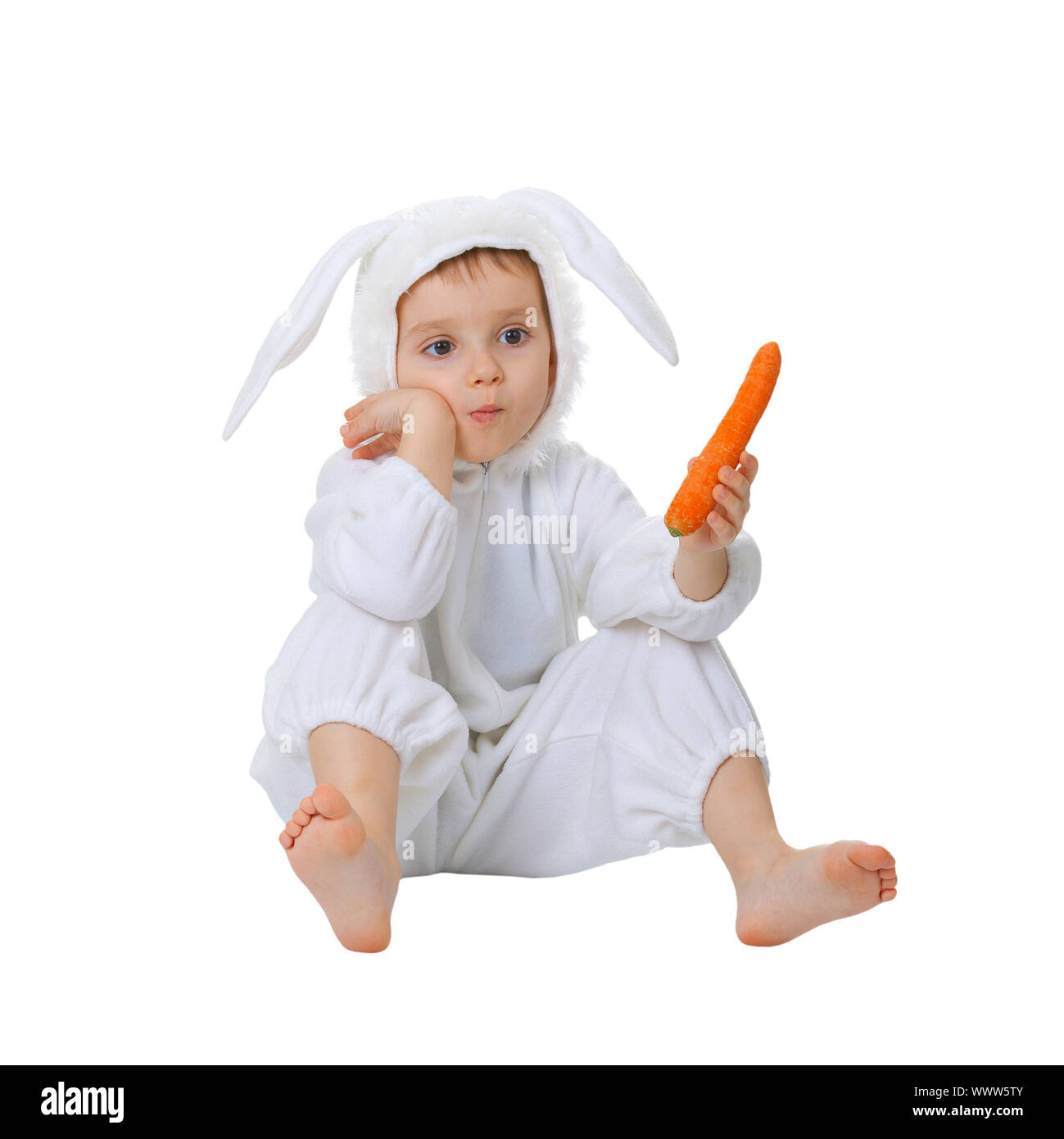 A child dressed as a rabbit with a carrot isolated on white background ...