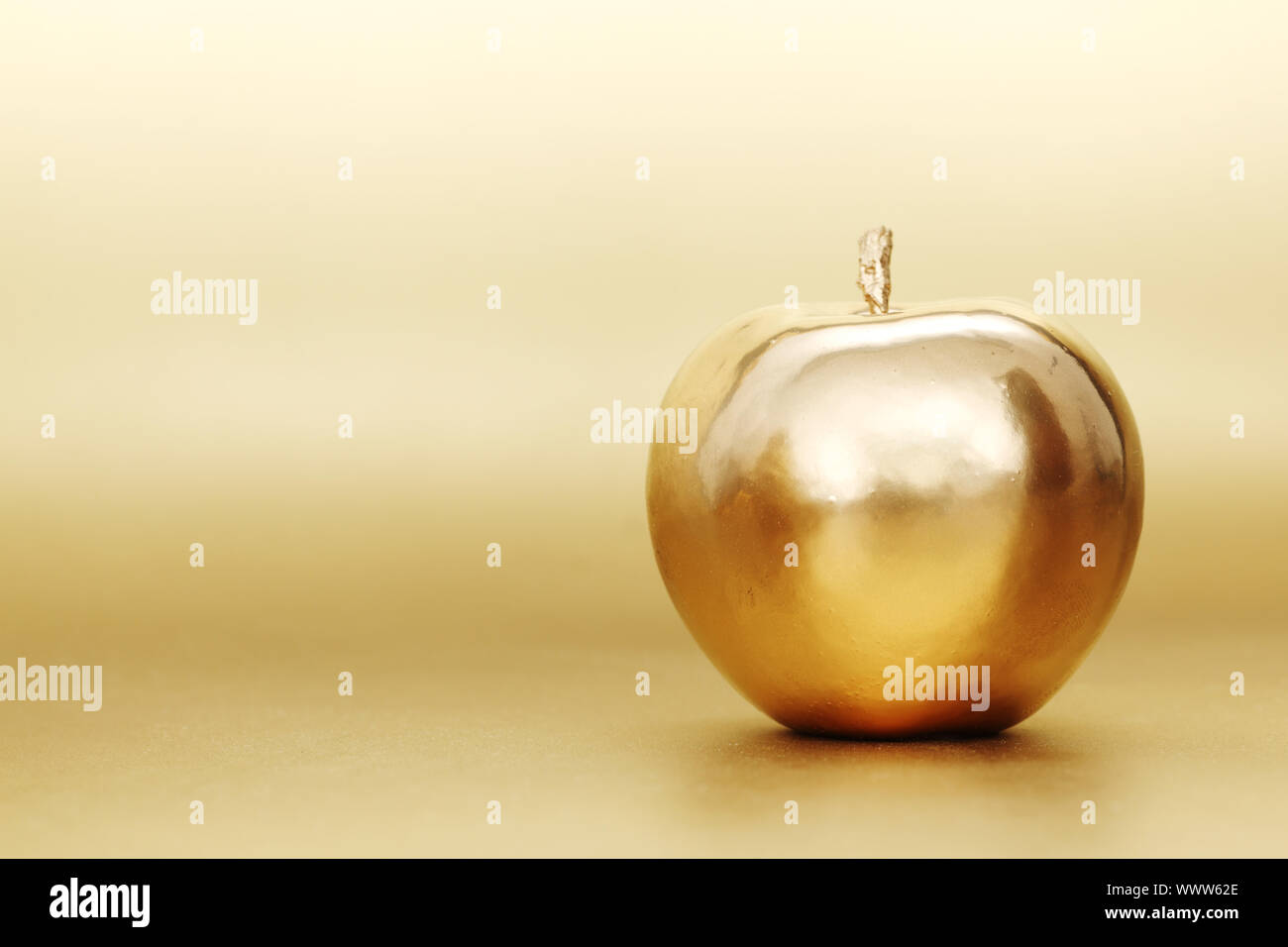 gold apple on gold background Stock Photo - Alamy
