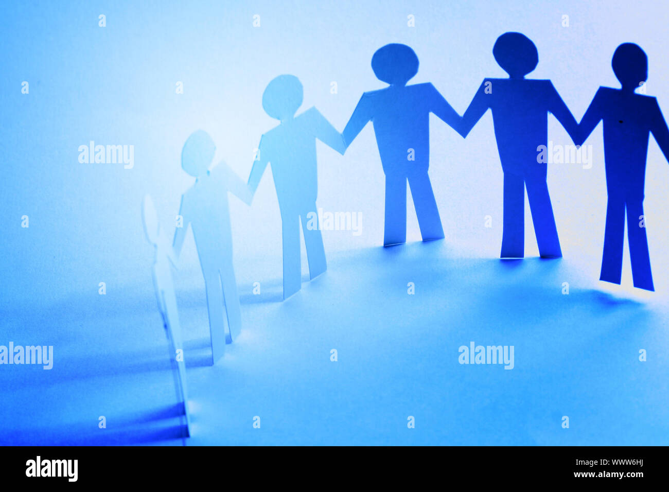 paper team linked together partnership concept Stock Photo - Alamy