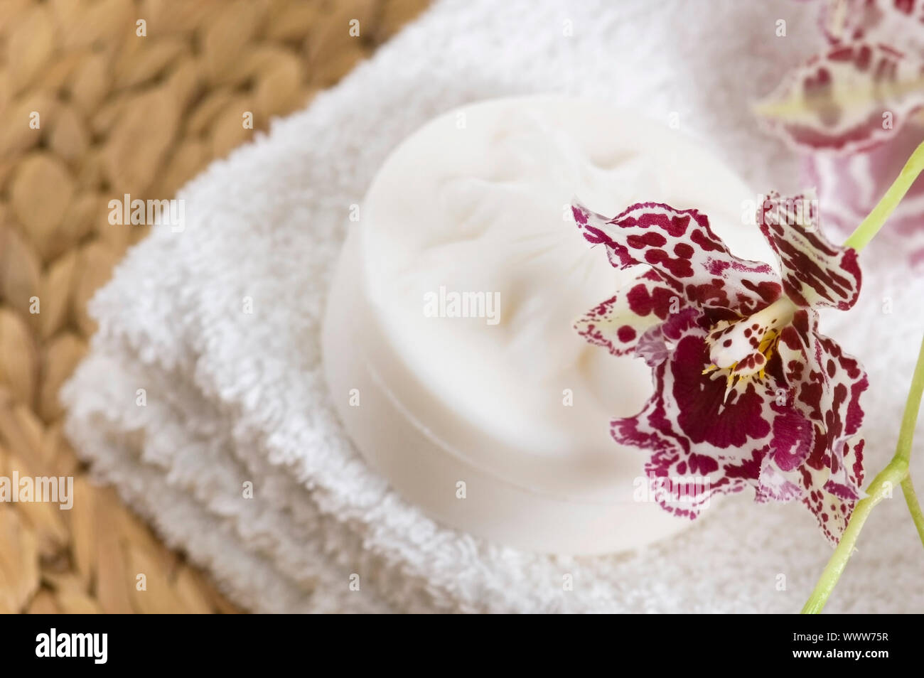 Spa items with white towels, natural soap and orchid Stock Photo - Alamy