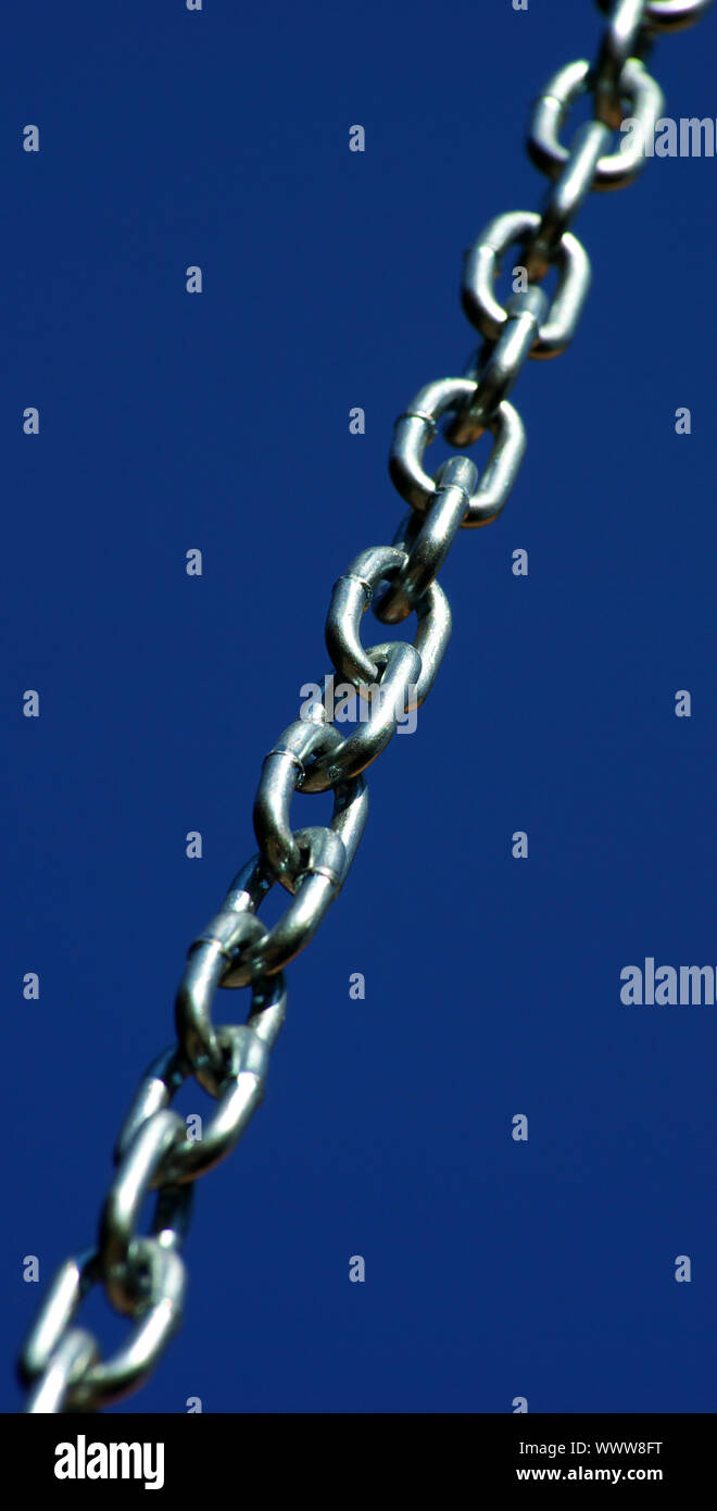 new chain is isolated on a dark blue background Stock Photo - Alamy
