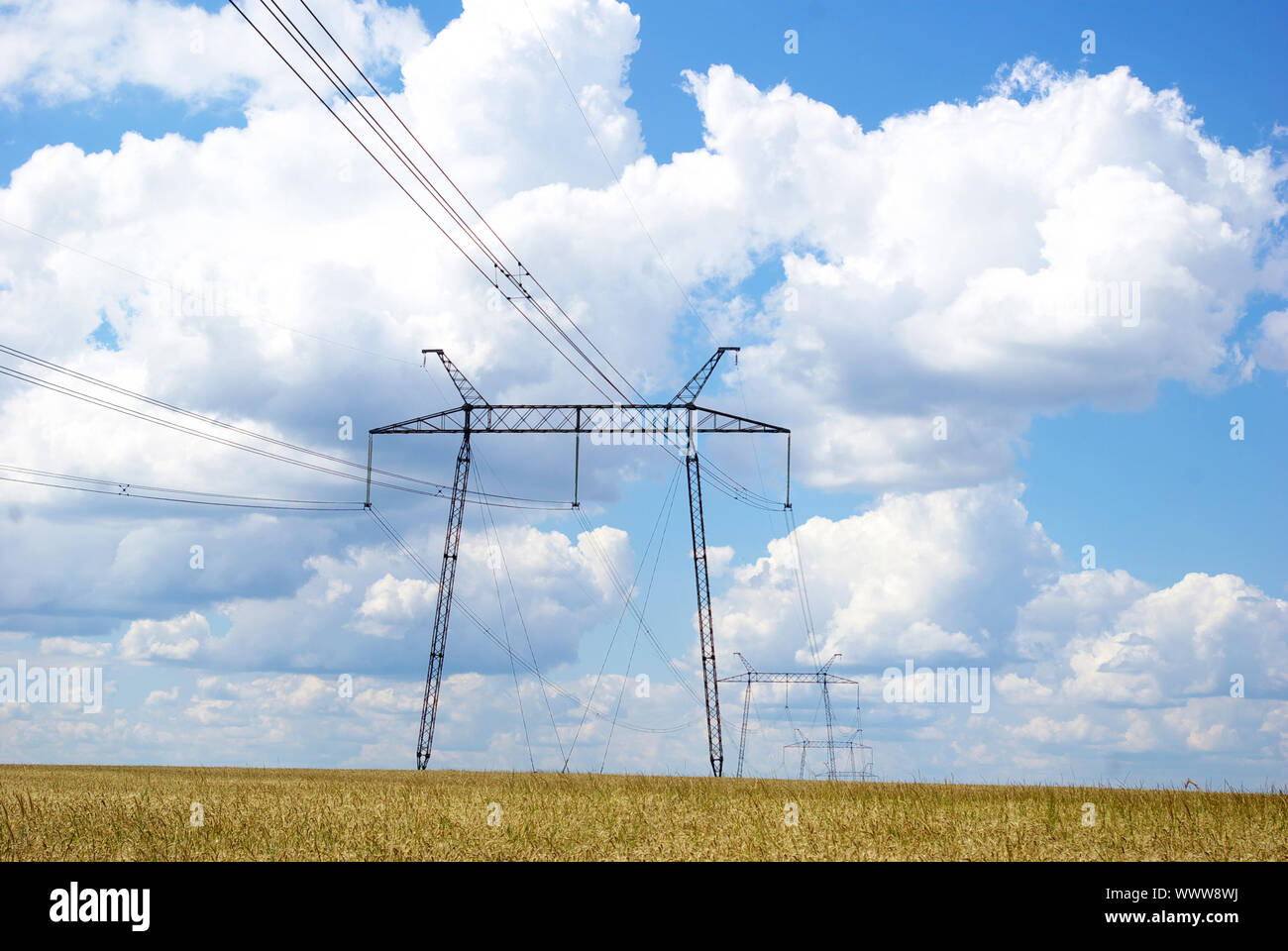 electrical powerlines with blue sky and white clouds Stock Photo - Alamy