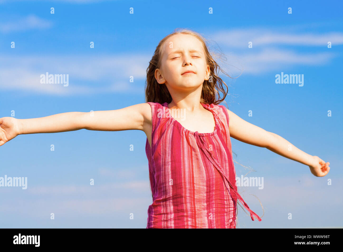 happy girl relaxing outdoors, soaking up the sun Stock Photo - Alamy