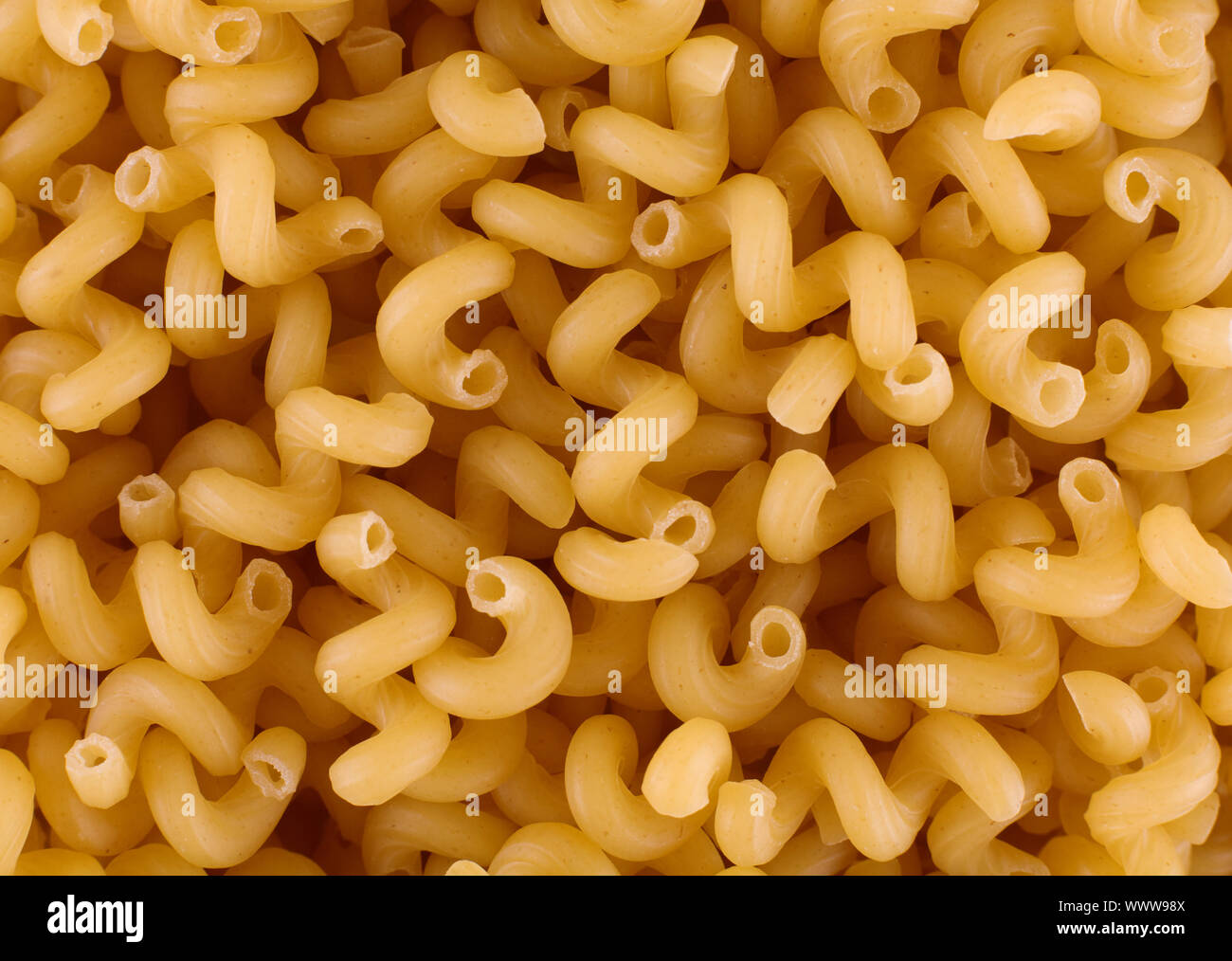 Texture consisting of dry macaroni on a plate surface Stock Photo - Alamy
