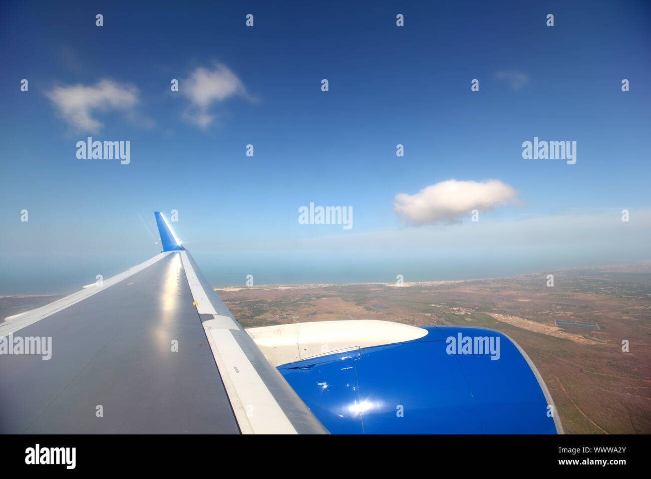 airplane fly in blue sky cloud around Stock Photo - Alamy