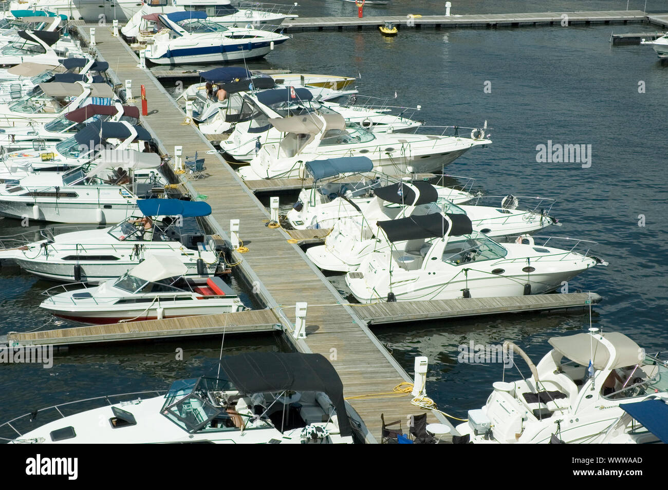 a bunch of small boats docked at a marina Stock Photo - Alamy