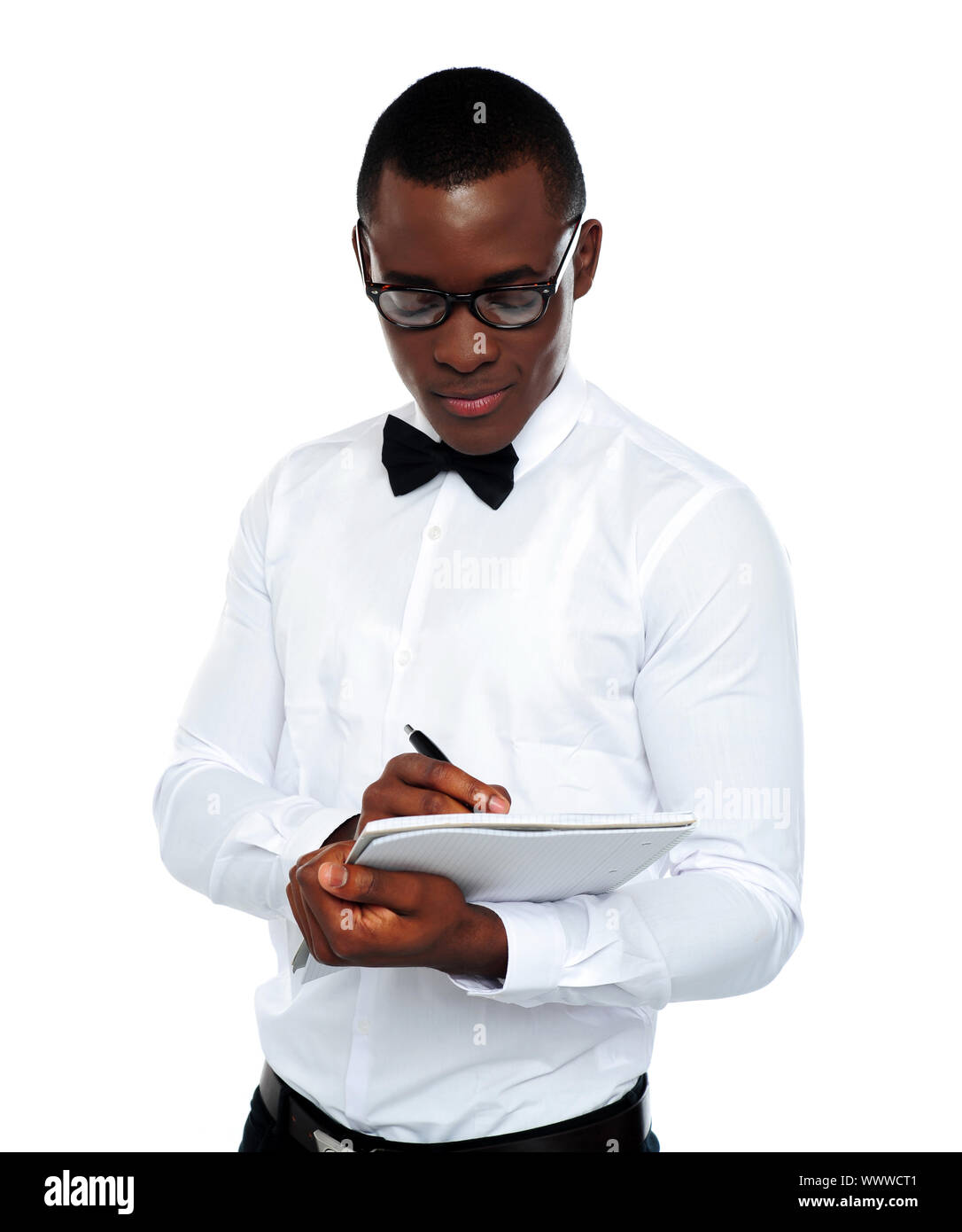 Confident young man writing on notepad isolated on white background ...