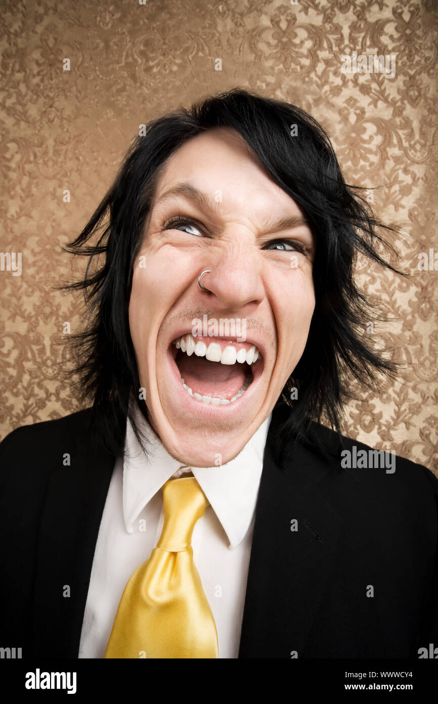 Screaming young man in a business suit and tie Stock Photo - Alamy