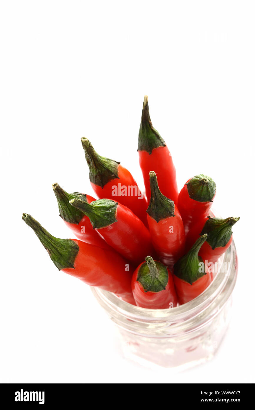 bunch of fresh red hot chilli chilies pepper in a glass jar, isolated ...