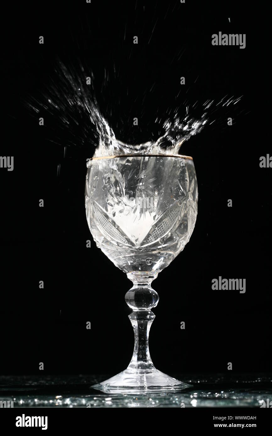 alcohol splash on black background Stock Photo - Alamy