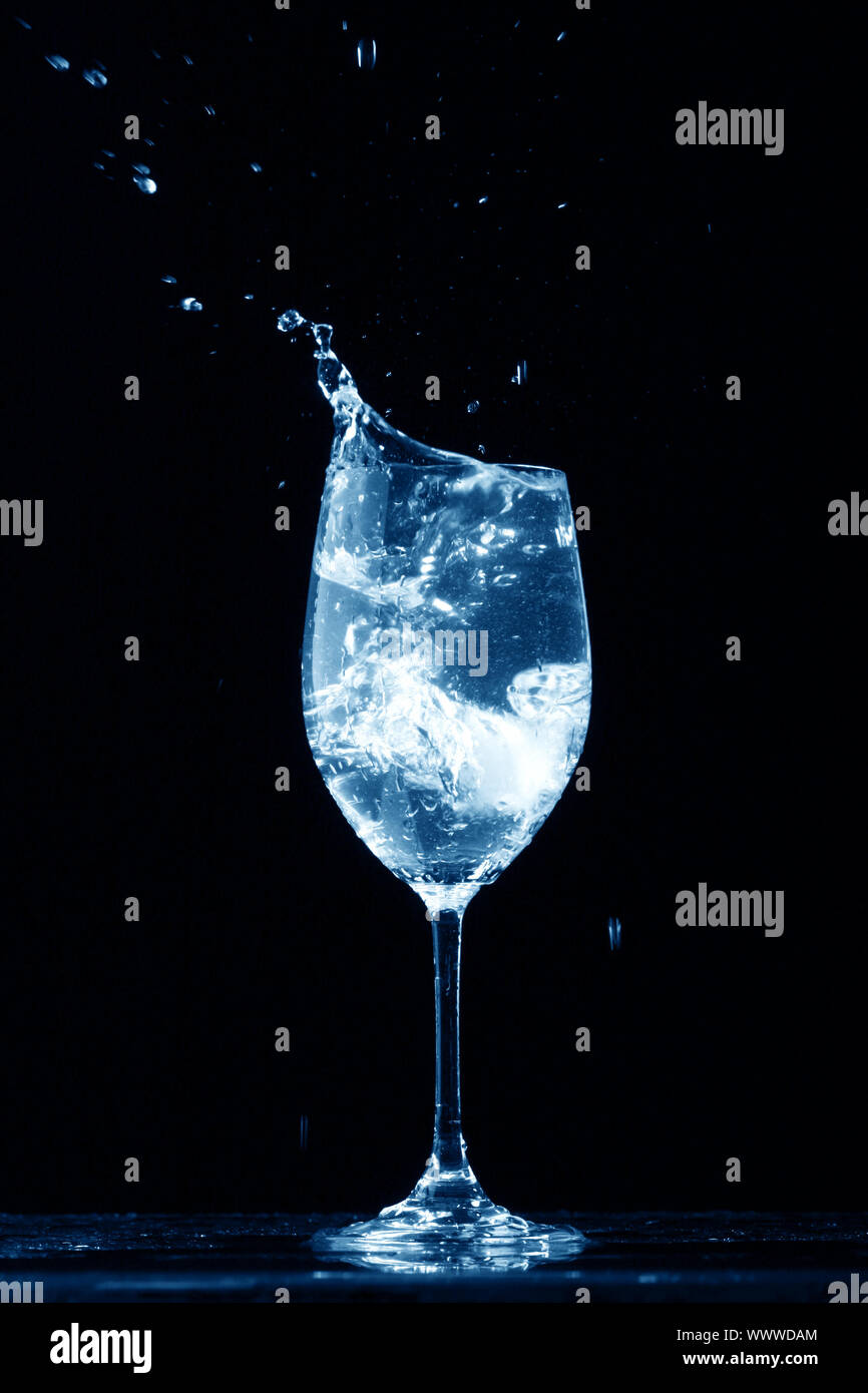 alcohol splash on black background Stock Photo - Alamy