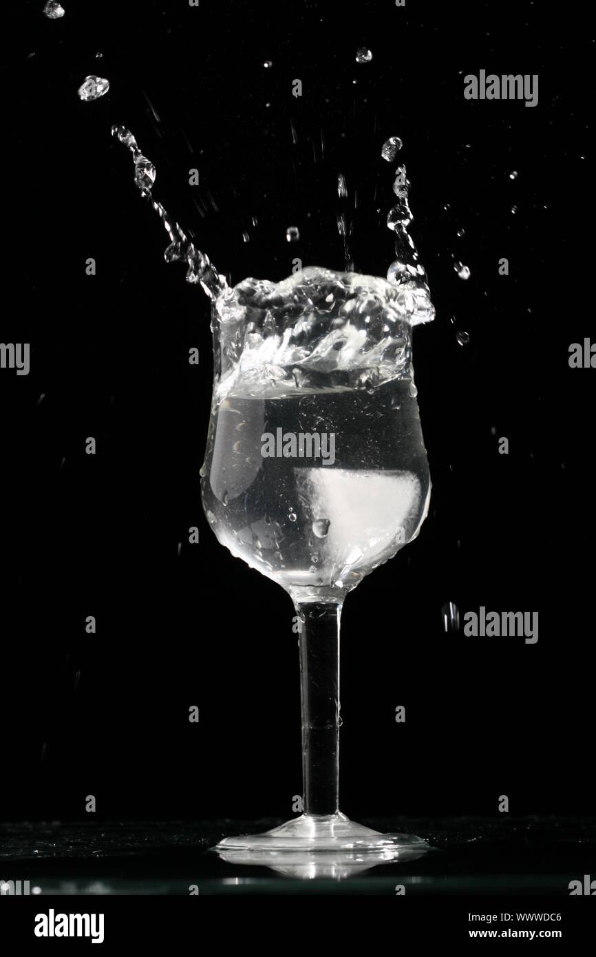 alcohol splash on black background Stock Photo - Alamy