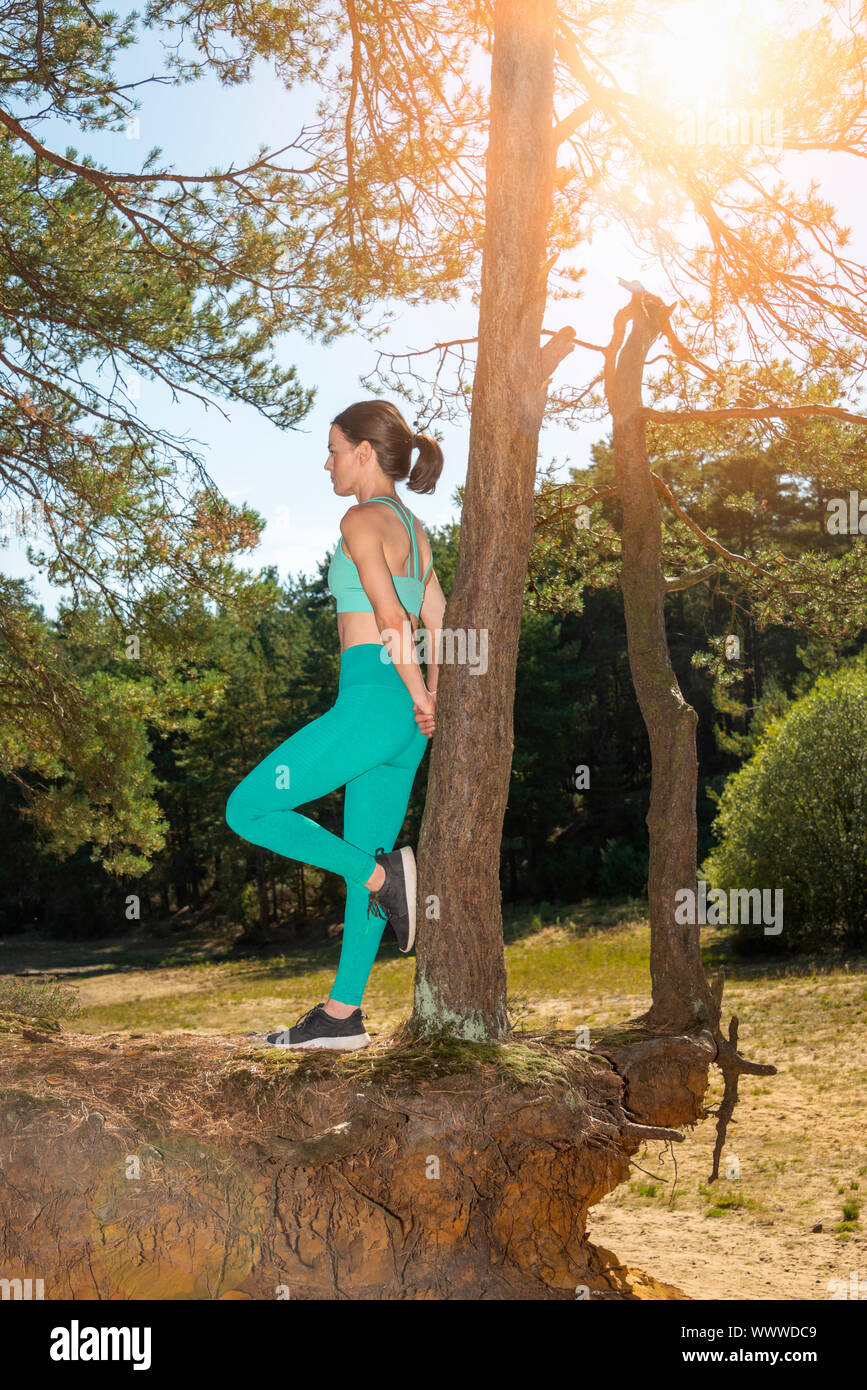 Athlete leaning against tree hi-res stock photography and images - Alamy
