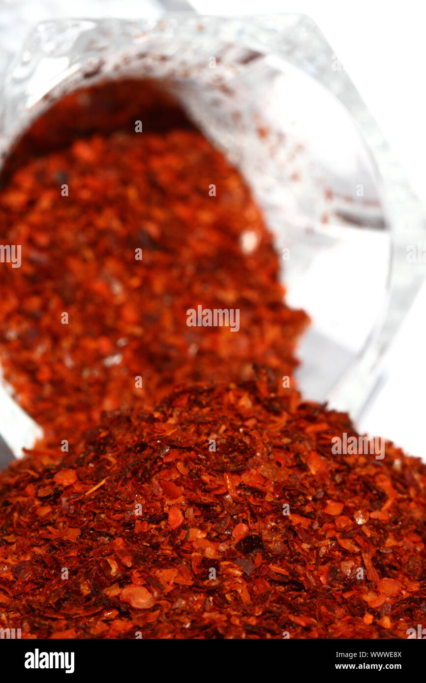 heap of Aleppo Flakes red chillies chilli pepper and upturned glass on ...