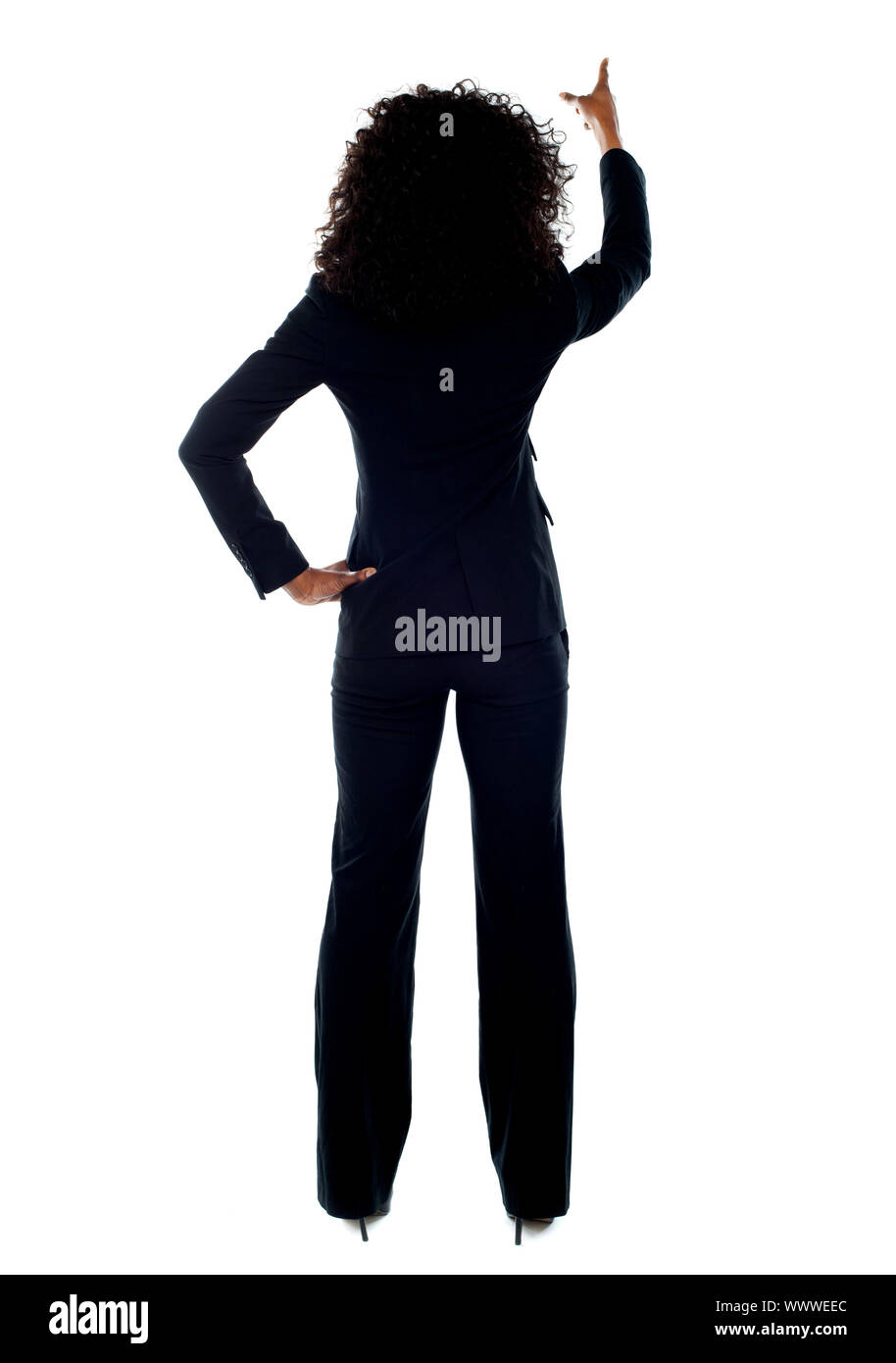 Full length rear view of female executive pointing at copy space Stock ...