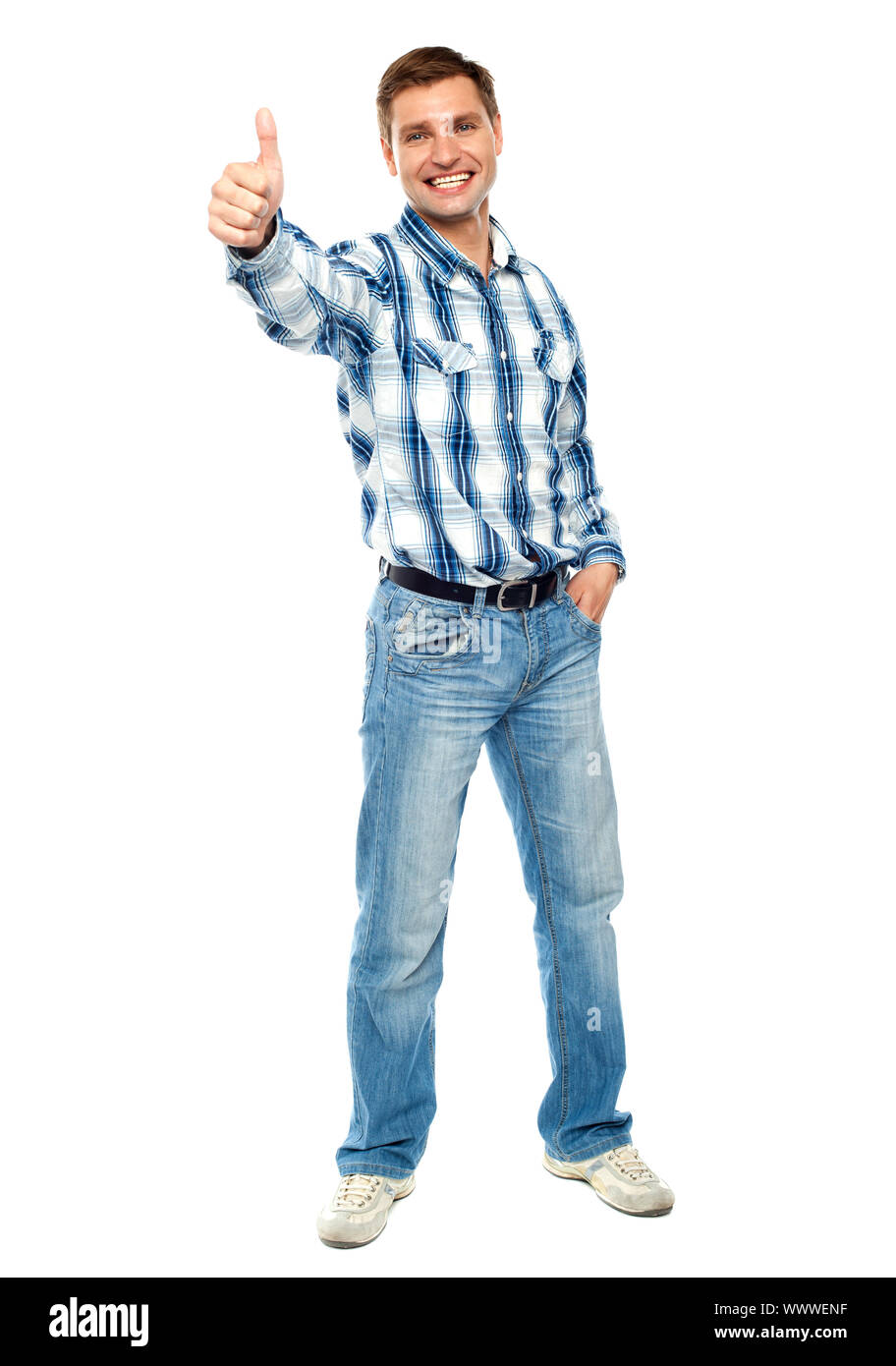 Smiling guy gesturing thumbs up isolated over white background Stock ...