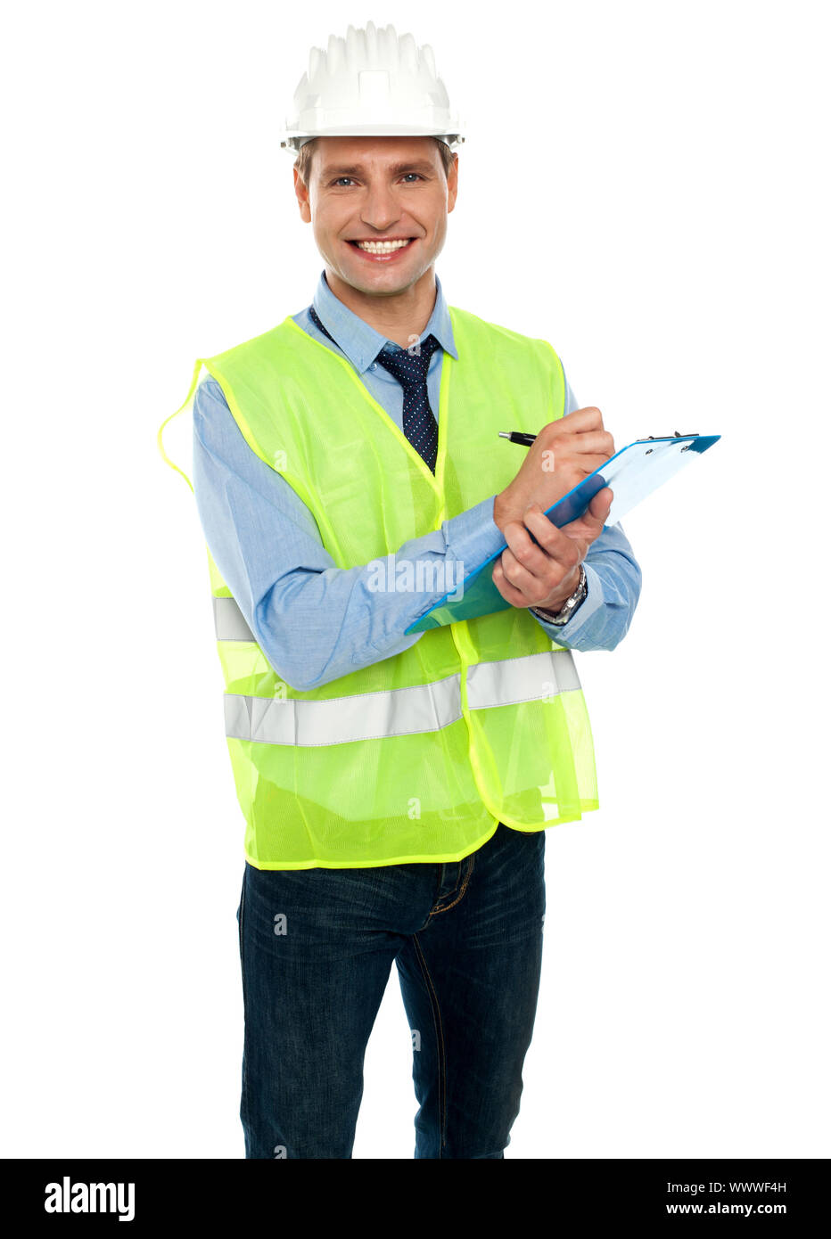 Smiling young architect writing notes isolated against white background ...