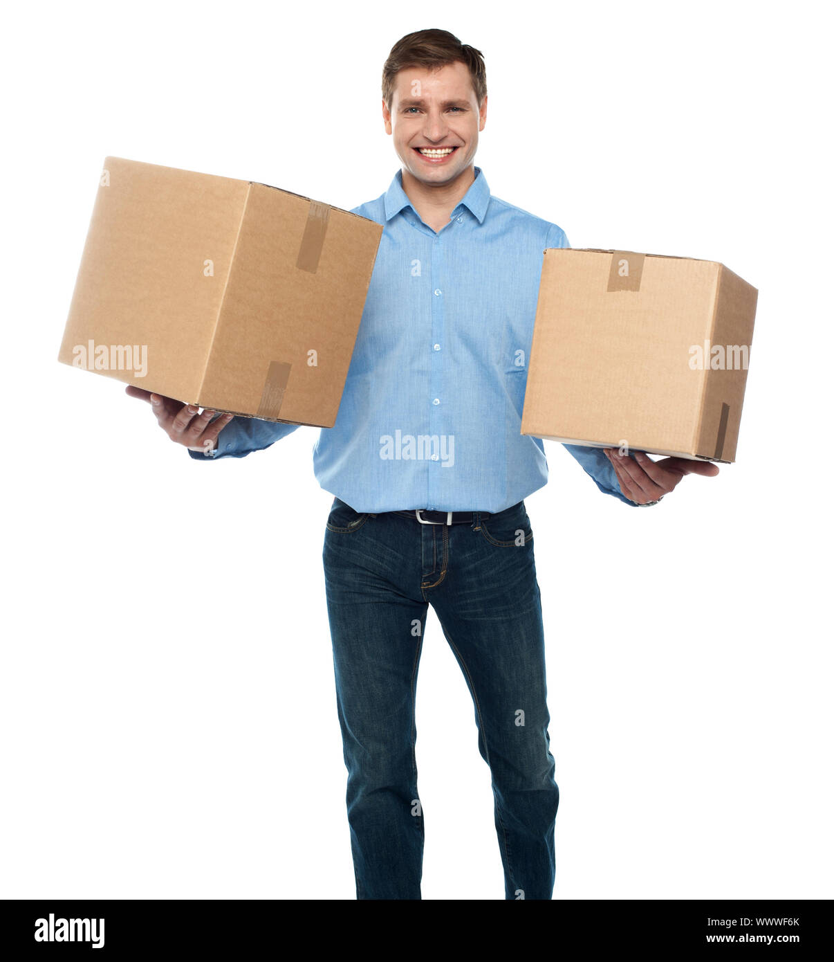 Portrait of a guy holding boxes in both hands. Smiling at camera Stock ...