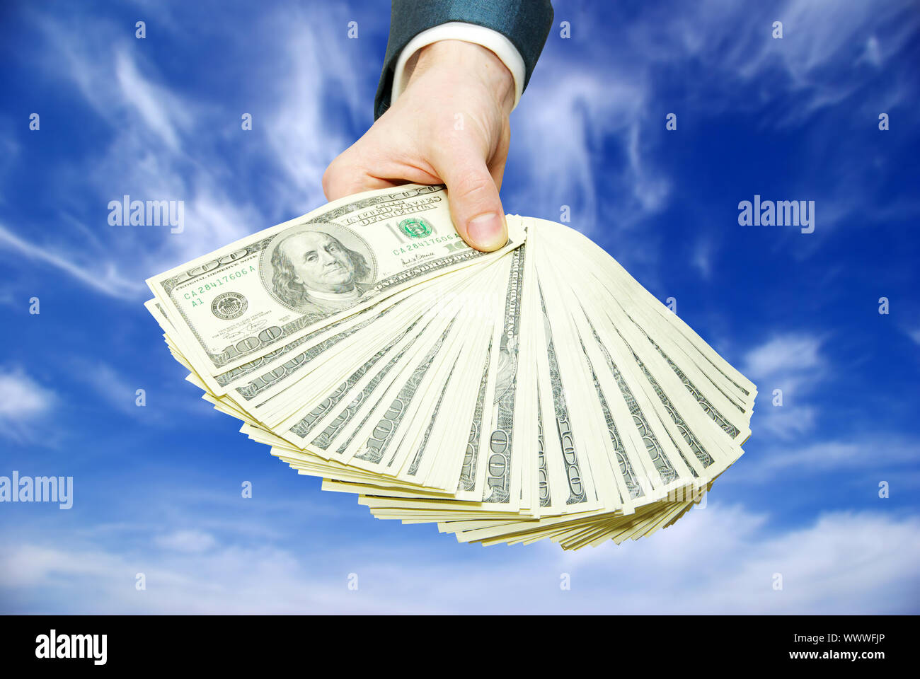 Hand with money isolated on sky background sky Stock Photo - Alamy