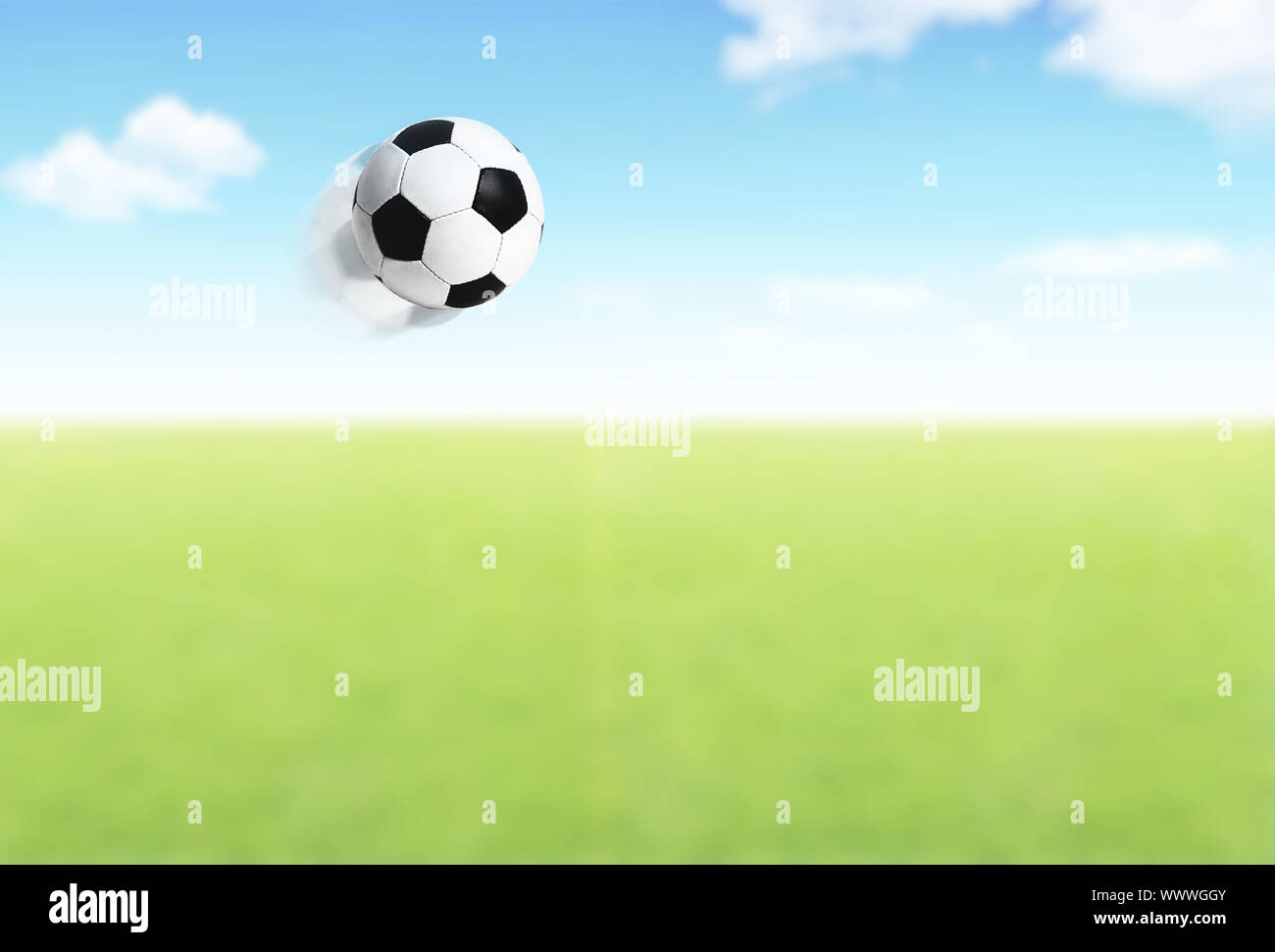 Football ball flying over field Stock Photo - Alamy