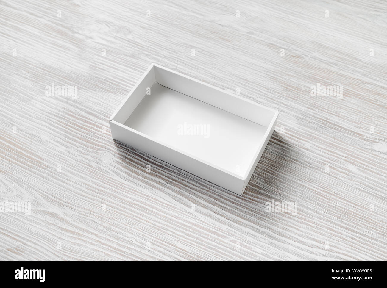 Blank opened box on light wood table background. Responsive design ...