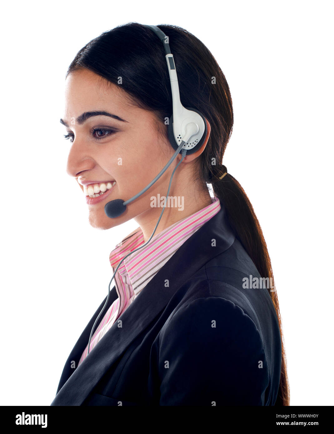 Side pose of pretty female customer care executive wearing headsets ...