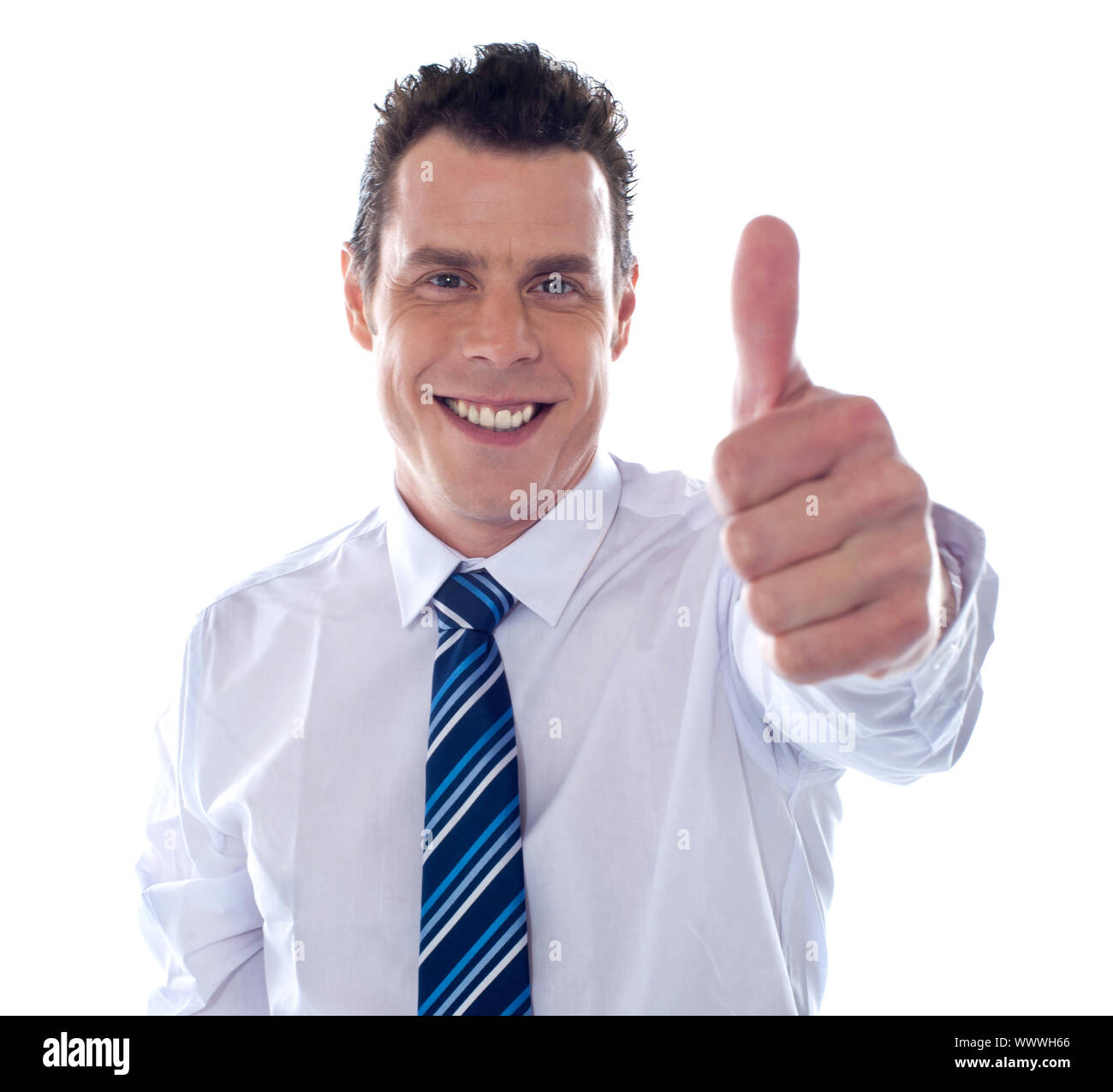 Smiling corporate man showing thumbs up against white Stock Photo - Alamy