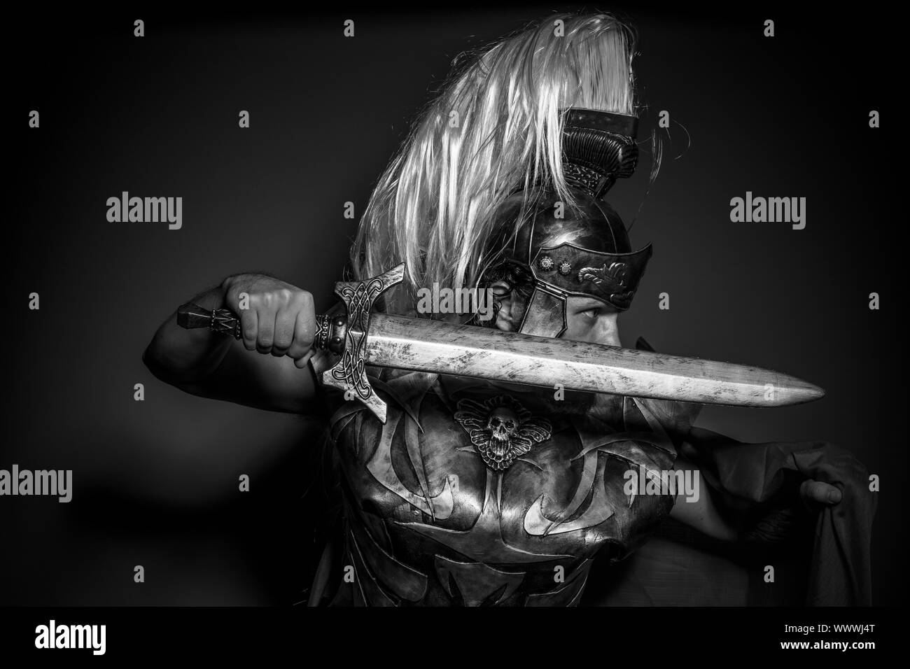 Roman centurion with armor and helmet with white chalk steel sword and ...