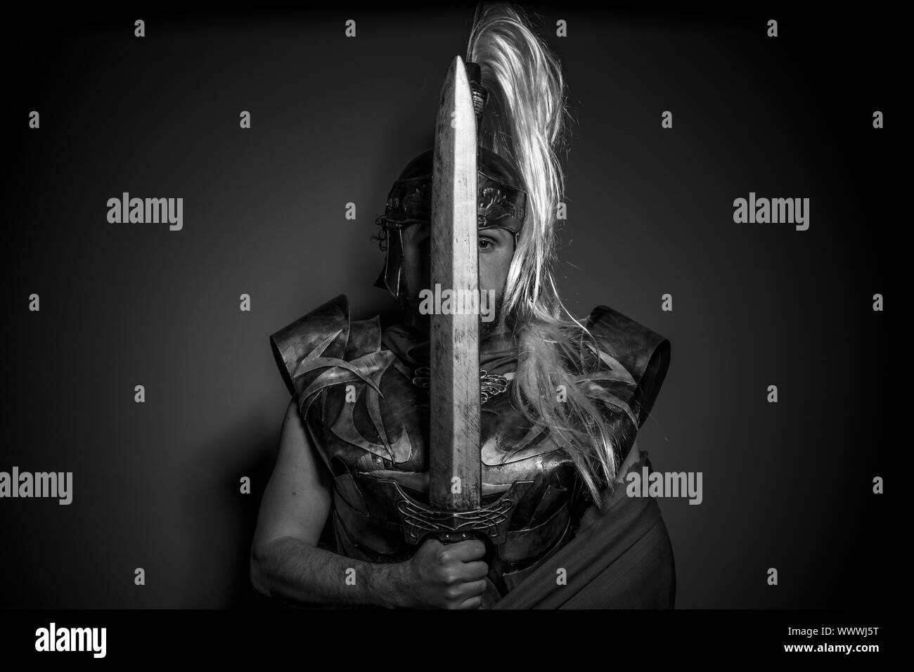 Roman centurion with armor and helmet with white chalk, steel sword and ...