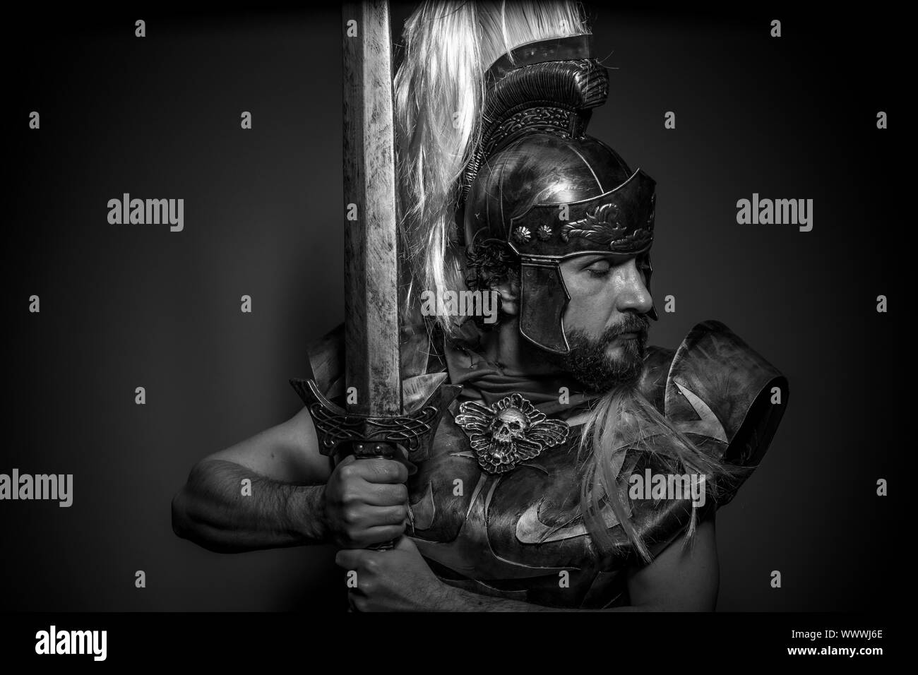Roman centurion with armor and helmet with white chalk, steel sword and ...