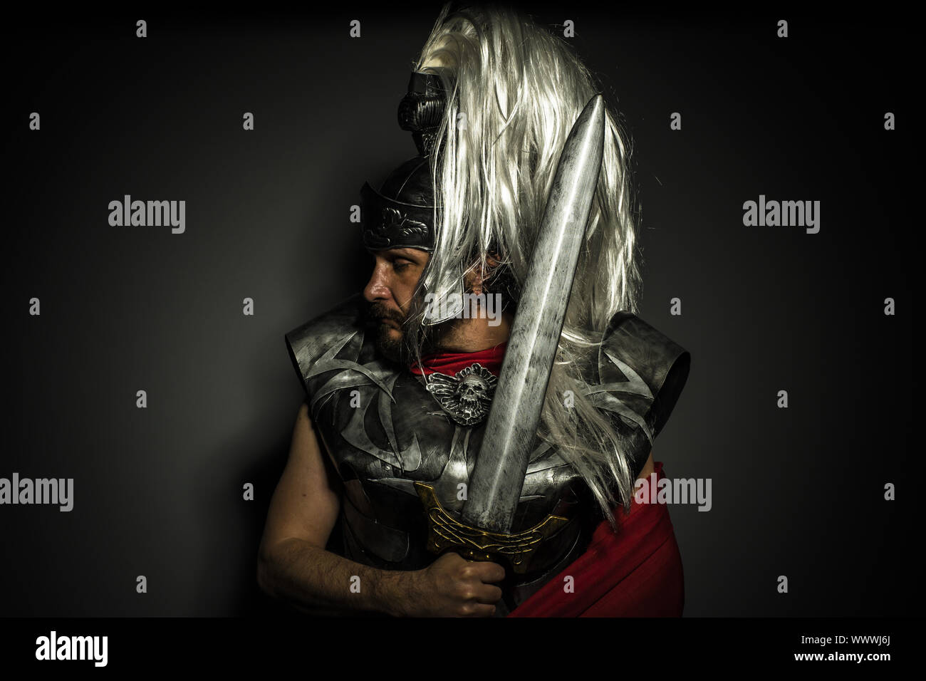 Roman centurion with armor and helmet with white chalk, steel sword and ...
